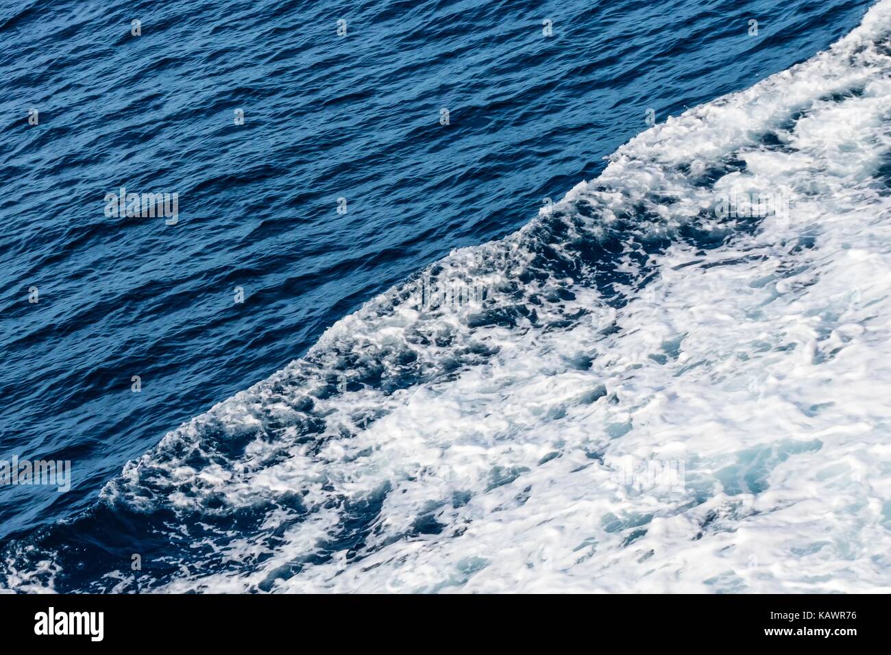 Horizontal photo of sea surface. Surface is diagonally divided to areas ...