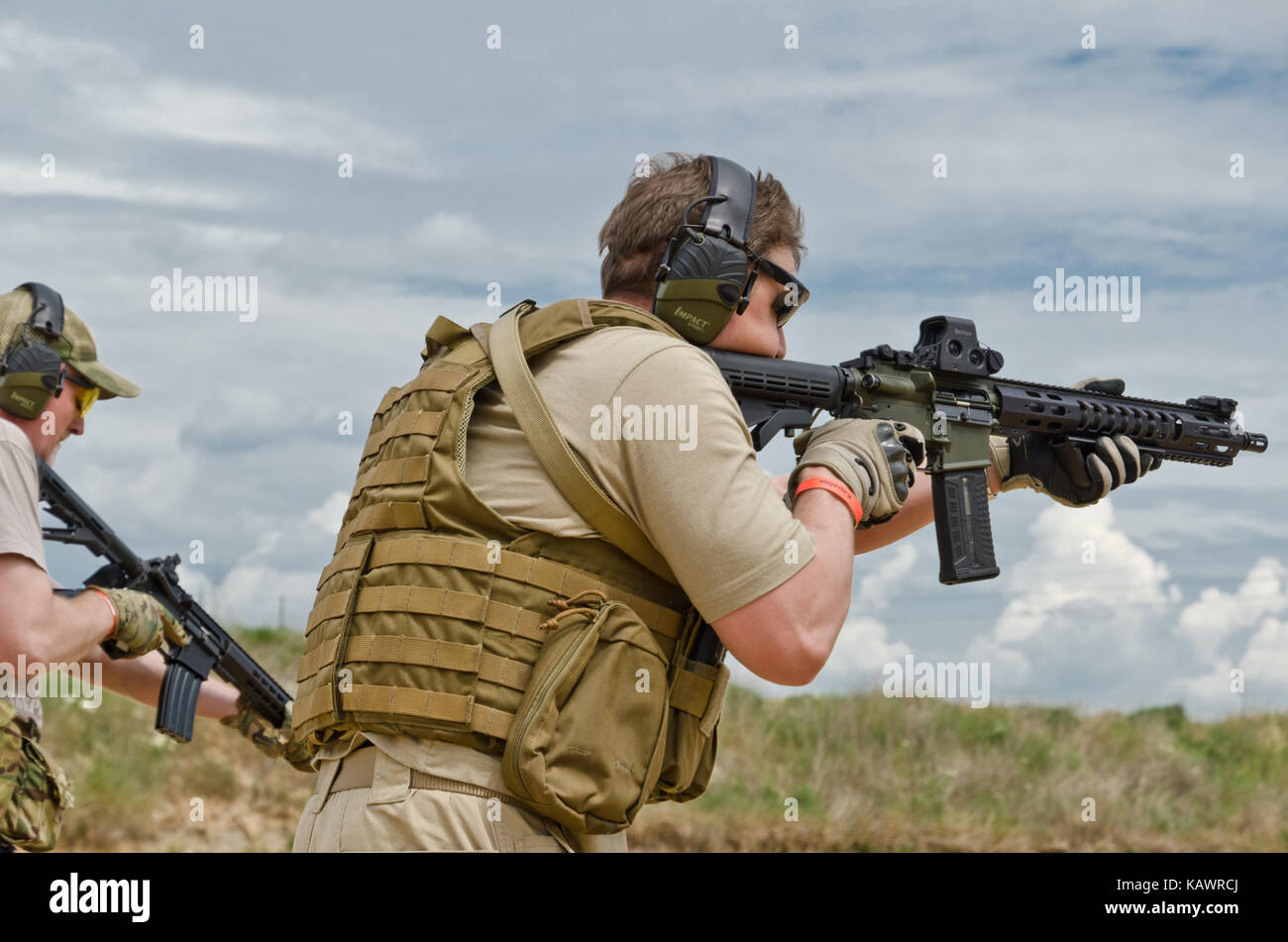 Men shooting outdoors Stock Photo - Alamy
