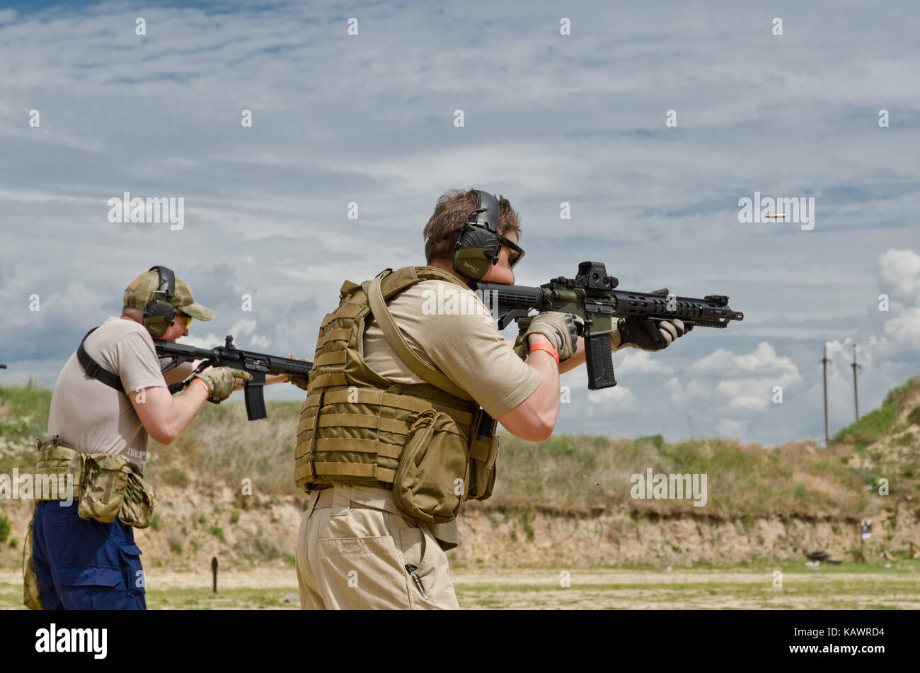Men shooting outdoors Stock Photo - Alamy