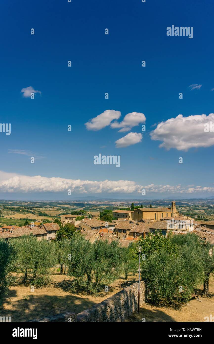 Vertical photo into Tuscany landscape in Italy. Few historic buildings ...
