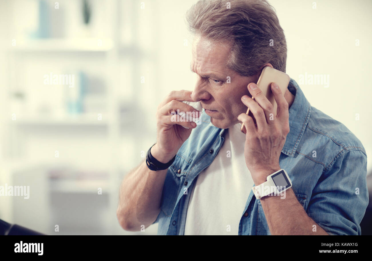 Serious handsome man talking on the phone Stock Photo - Alamy