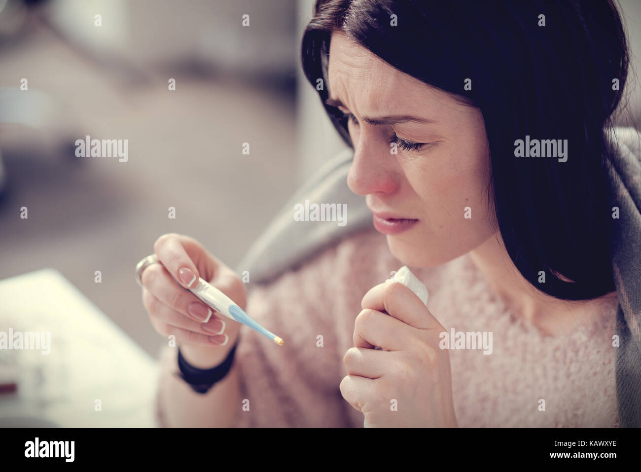 Cheerless sad woman having fever Stock Photo - Alamy