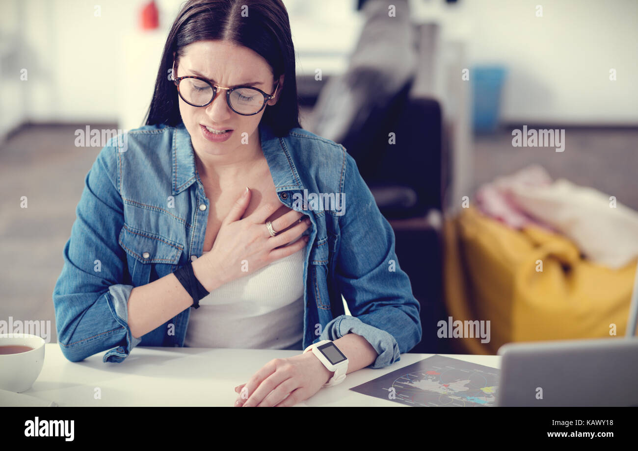 Unhappy young woman feeling unwell Stock Photo - Alamy