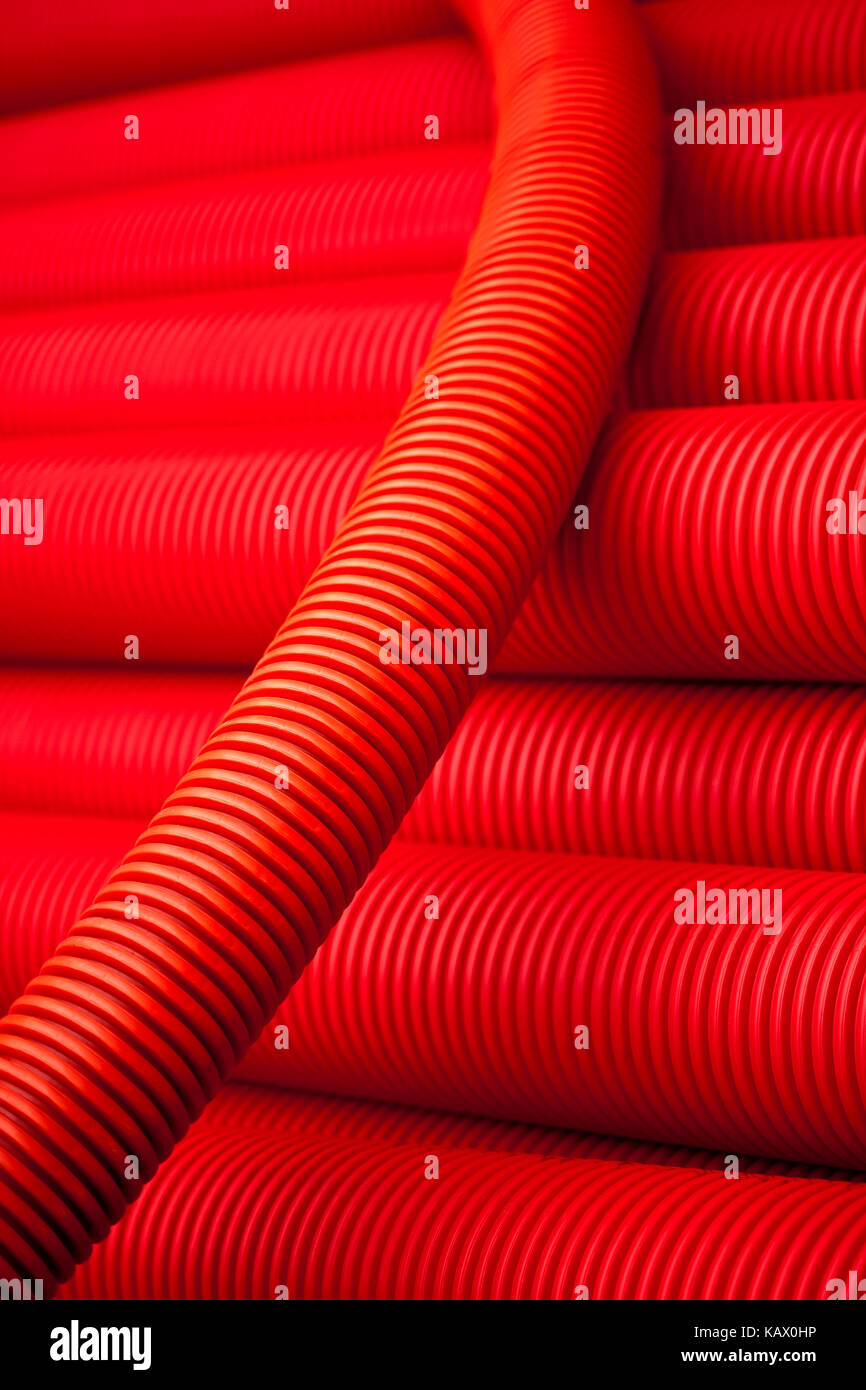 Background of red plastic pipes on a construction site Stock Photo - Alamy