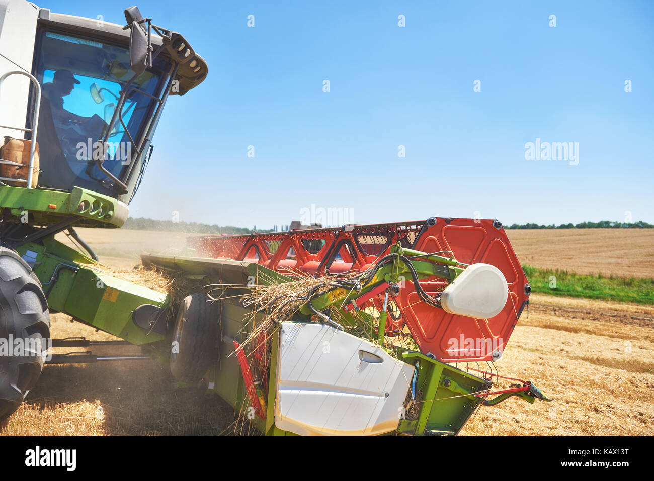 close view of modern combine harvester in action Stock Photo - Alamy