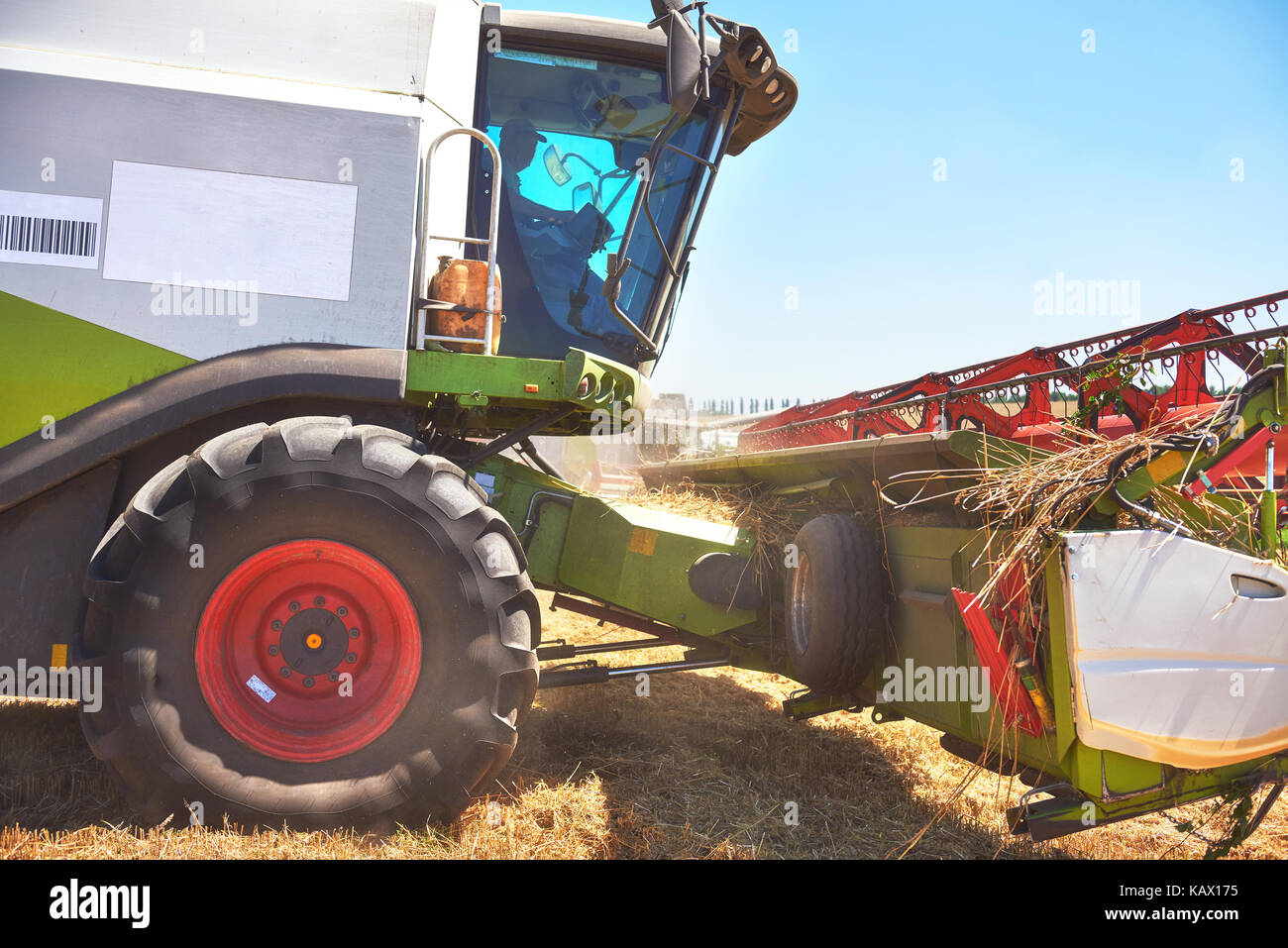 close view of modern combine harvester in action Stock Photo - Alamy