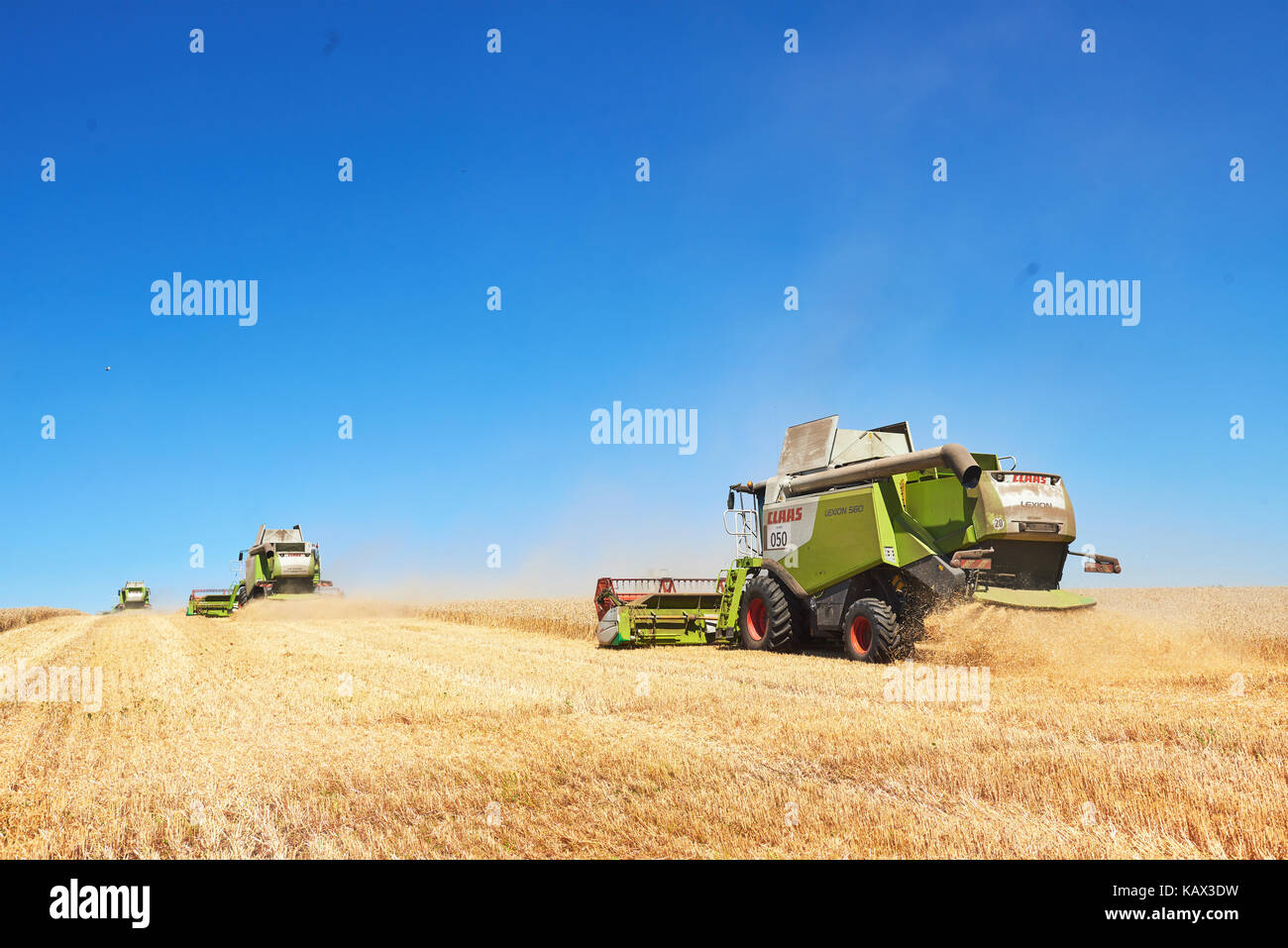 Combines at work during wheat harvest hi-res stock photography and ...