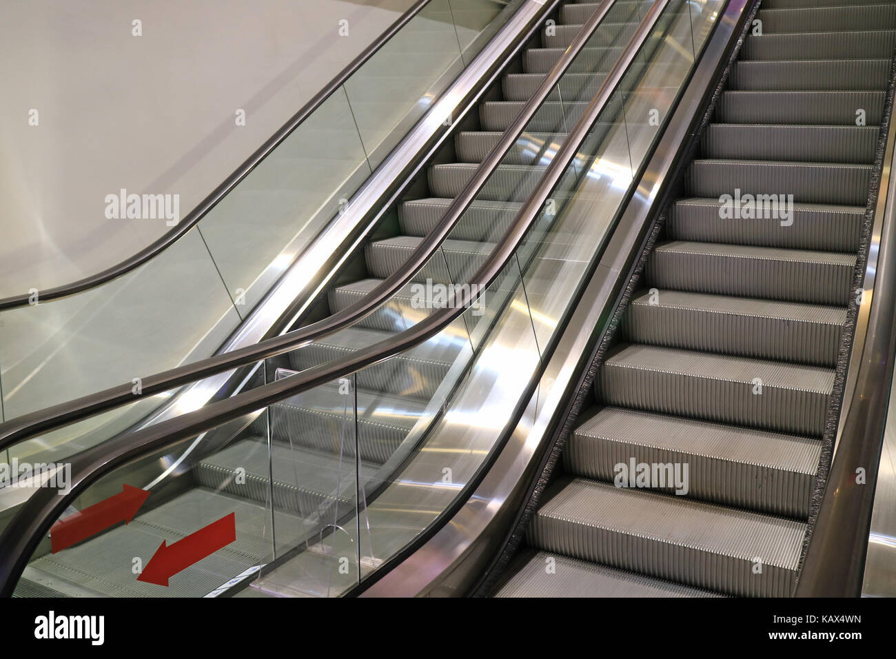 Double escalator staircase of a shopping mall, leading up and down from ...