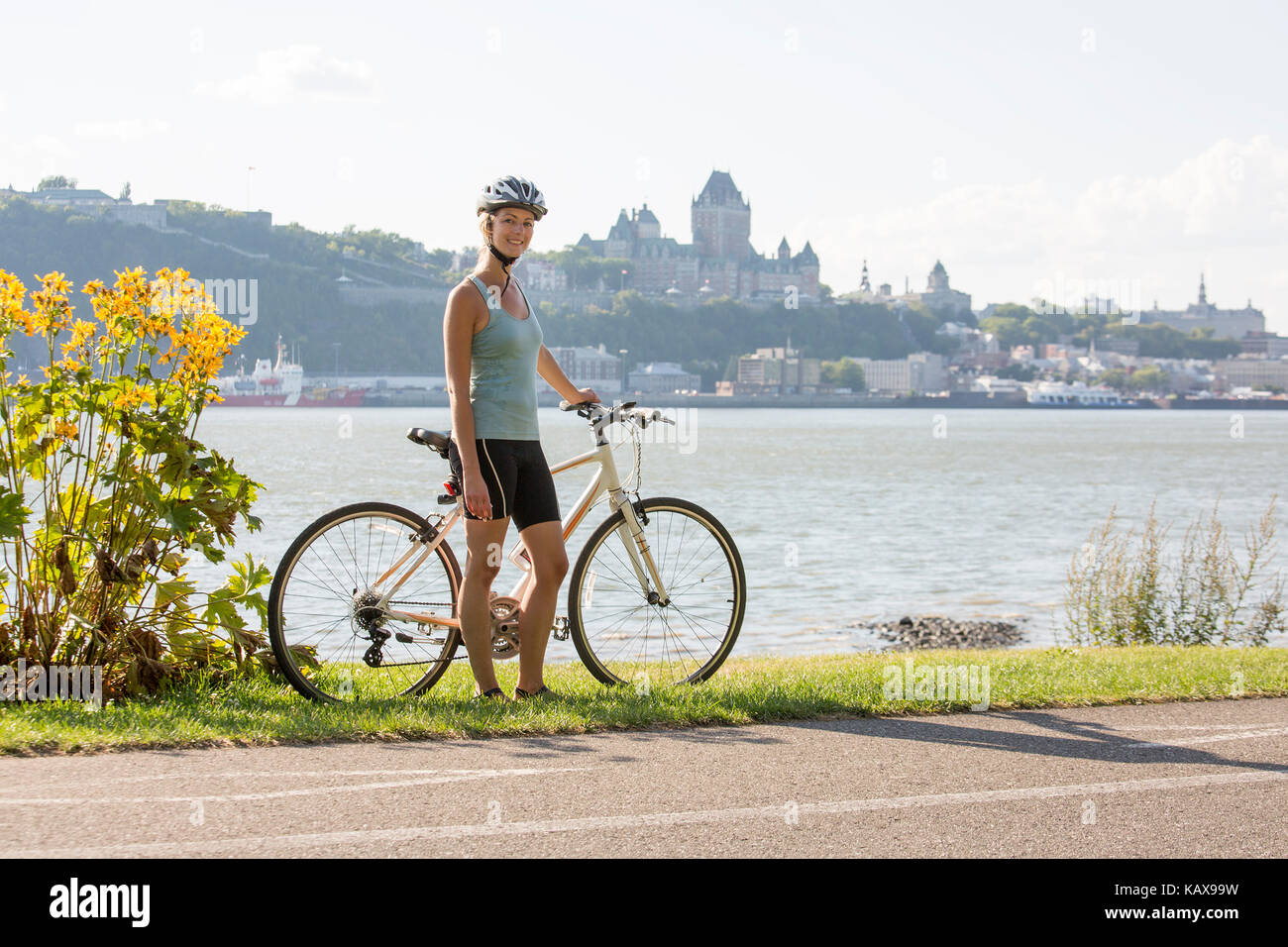 Young Woman Riding Bike outside with quebec view Stock Photo - Alamy