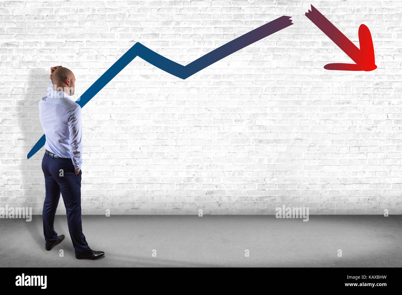 View of a Businessman in front of a wall thinking about problem facing ...