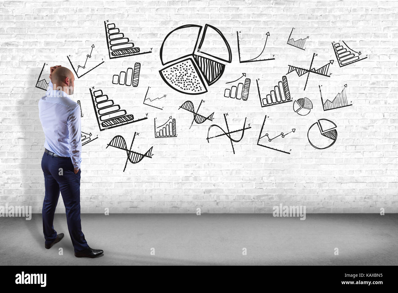 View of a Businessman in front of a wall thinking about a hand drawn ...