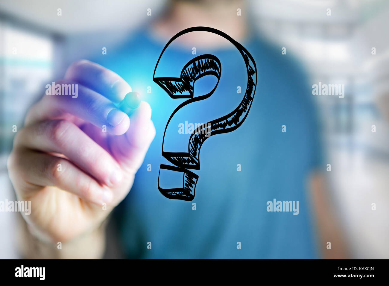 View of Man hand drawing question mark icon on a futuristic interface ...