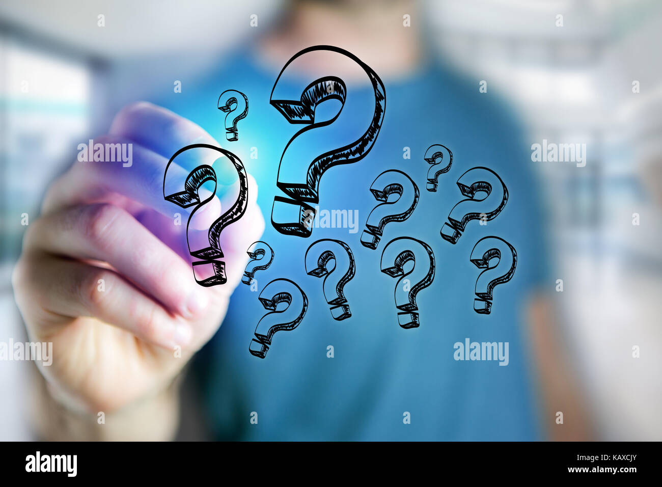 View of Man hand drawing question mark icon on a futuristic interface ...