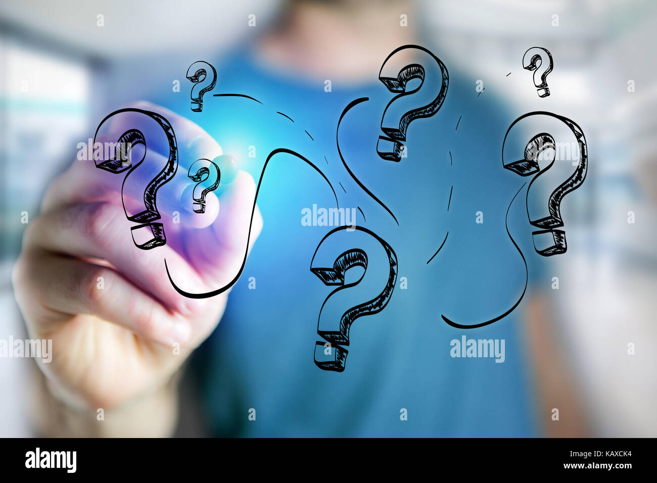 View of Man hand drawing question mark icon on a futuristic interface ...