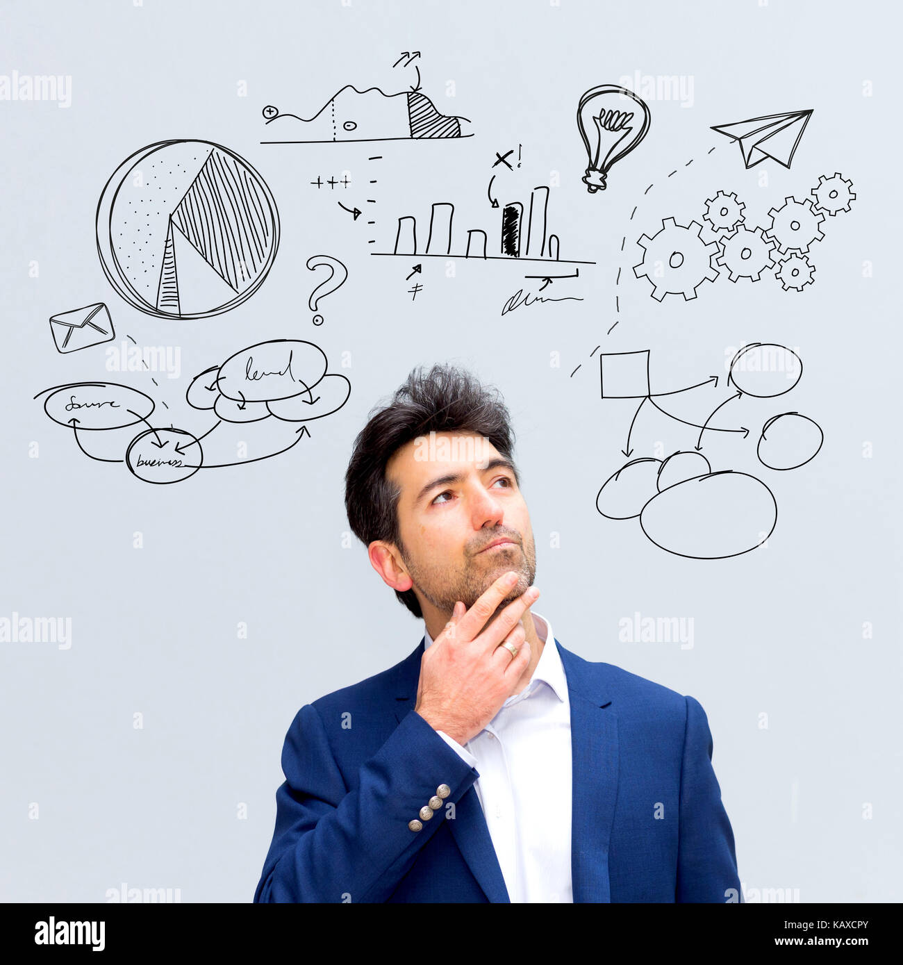 Portrait view of an attractive dubious business man with business icons ...