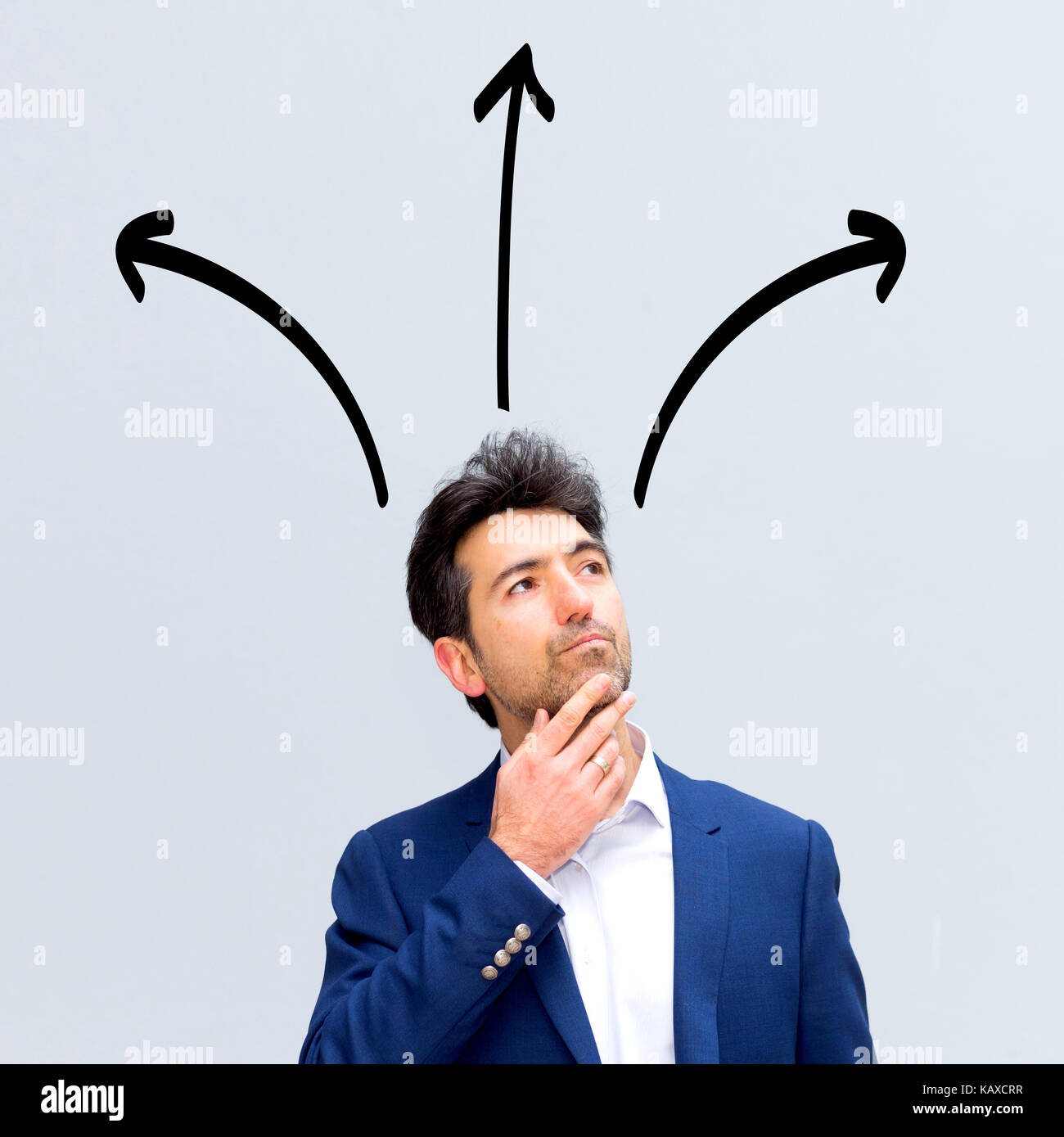 Portrait view of an attractive business man with arrows over his head ...