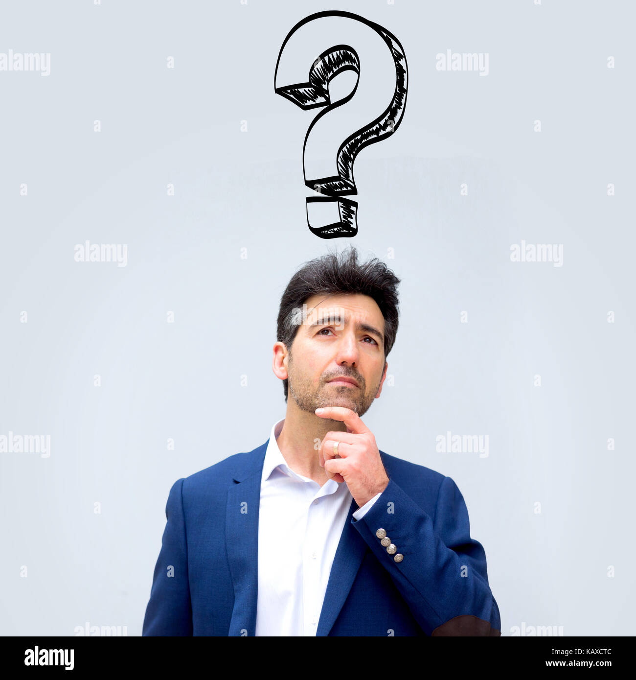 Portrait view of an attractive stressed business man with question mark ...