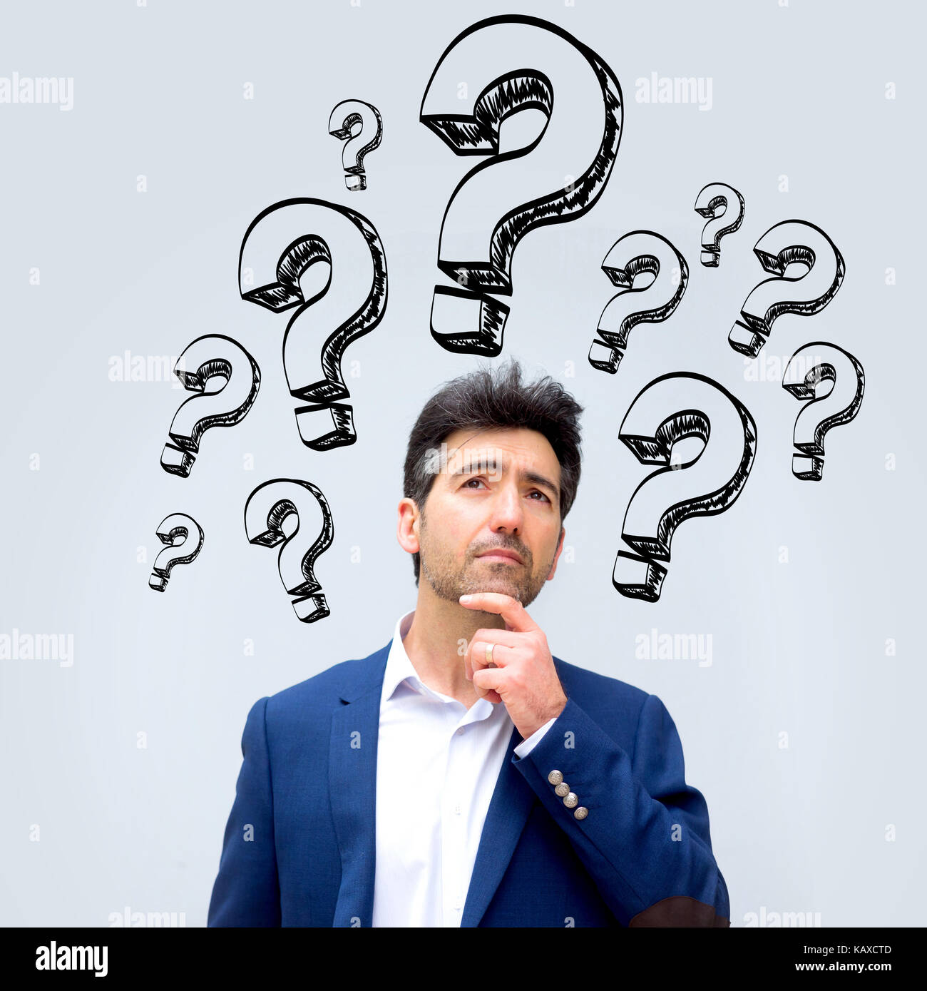 Portrait view of an attractive stressed business man with question mark ...