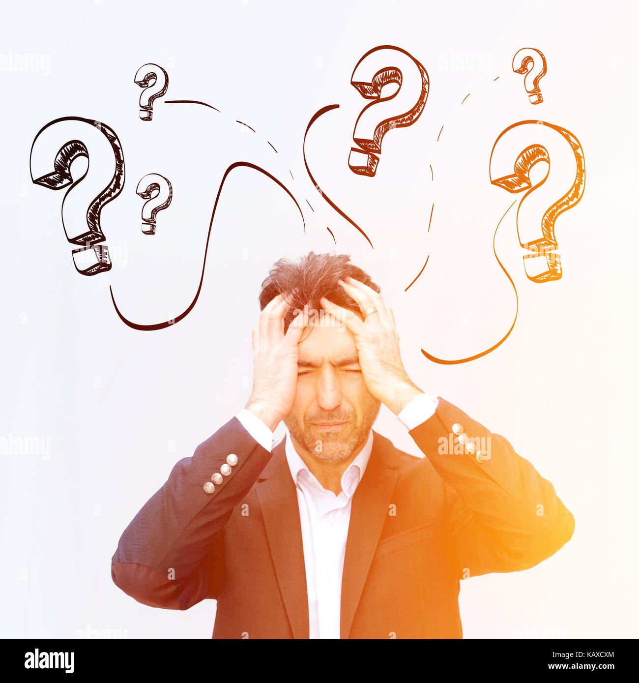 Portrait view of an attractive stressed business man with question mark ...