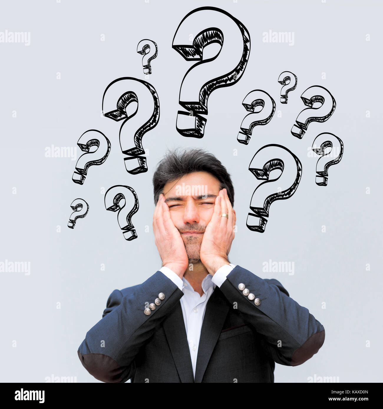 Portrait view of an attractive stressed business man with question mark ...