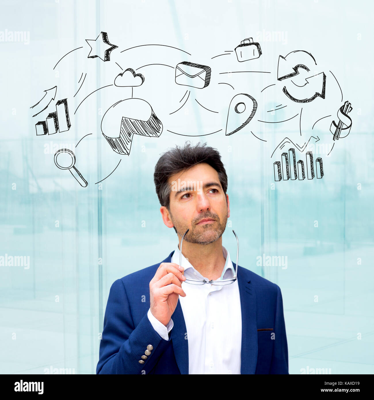 Portrait view of an attractive dubious business man with business icons ...