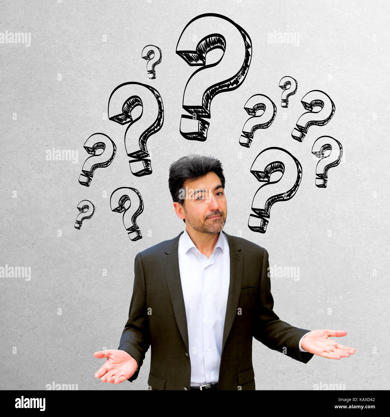 Portrait view of an attractive stressed business man with question mark ...