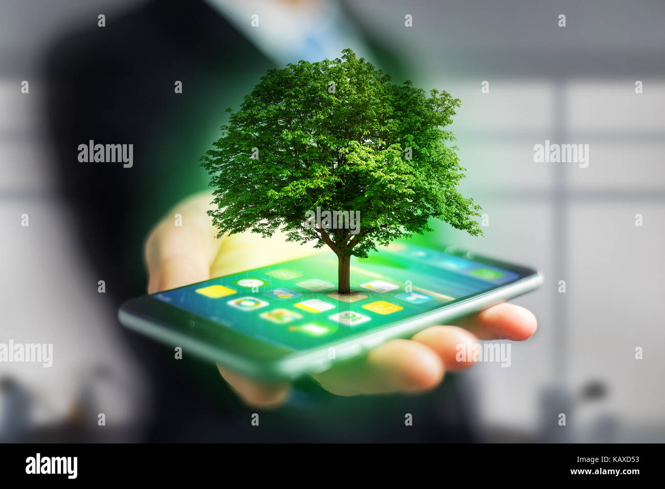 View of a Green tree going out of a smartphone - Ecology concept Stock ...