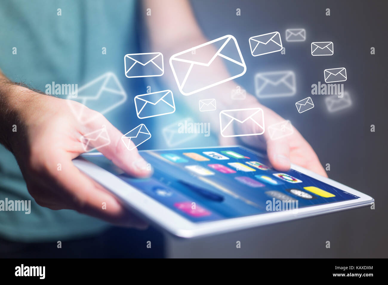 Concept view of sending email on tablet interface with message icon ...