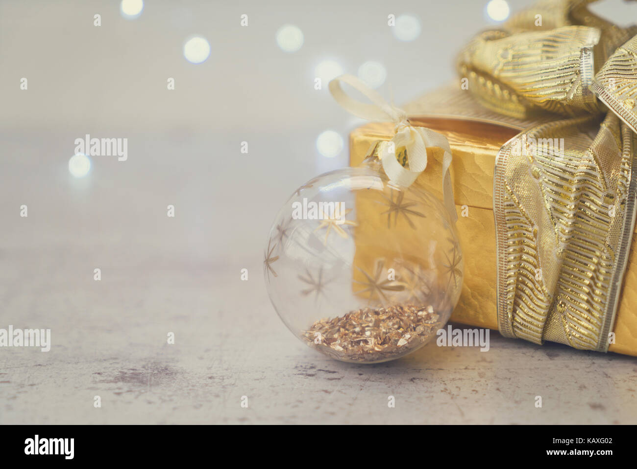 Christmas golden present box with christmas ball close up, retro toned ...