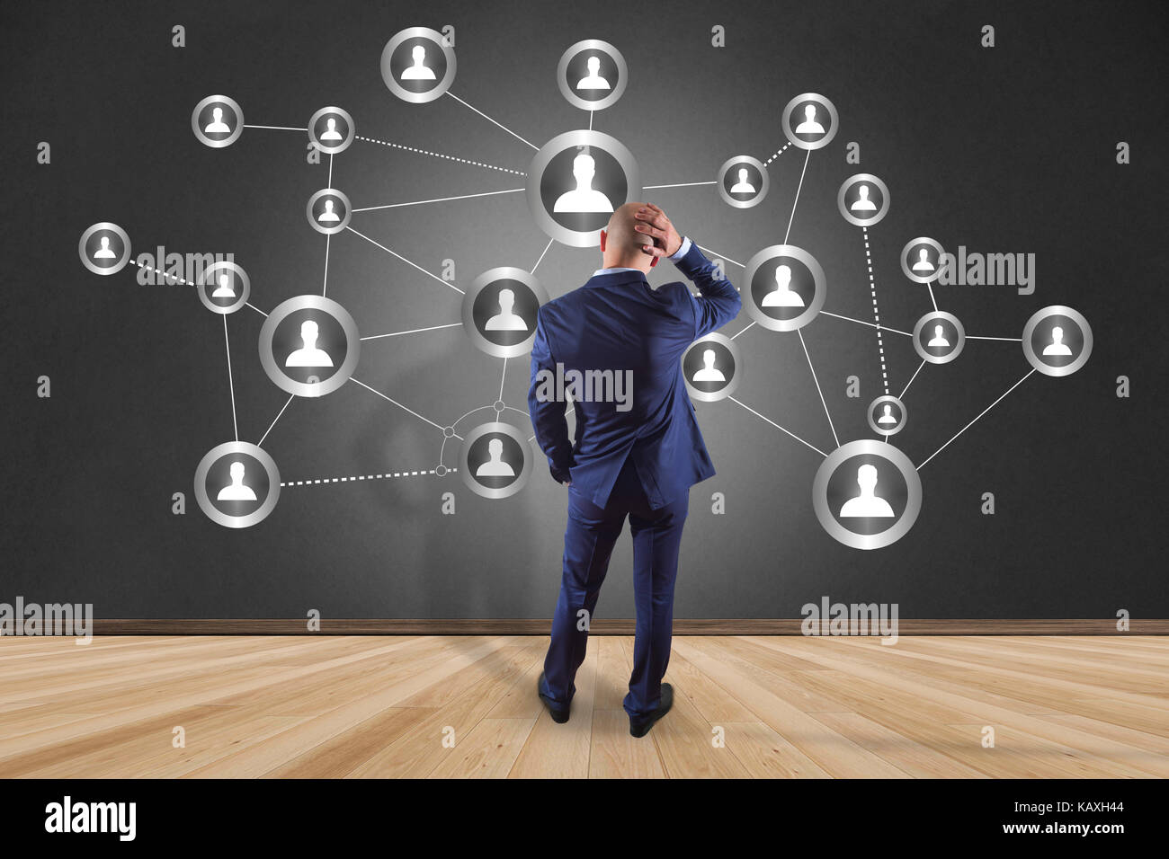 View of a Businessman in front of a wall with a business network ...
