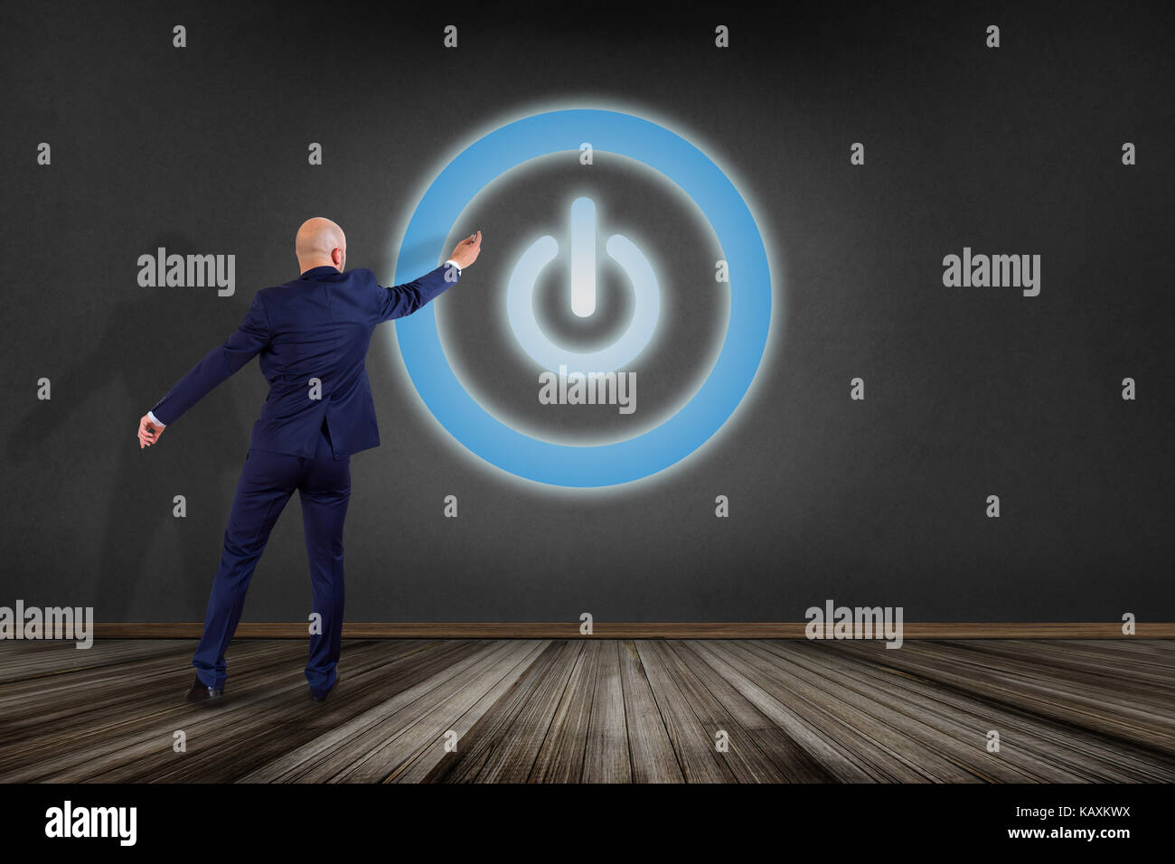 View of a Businessman in front of a wall with Power button symbol ...