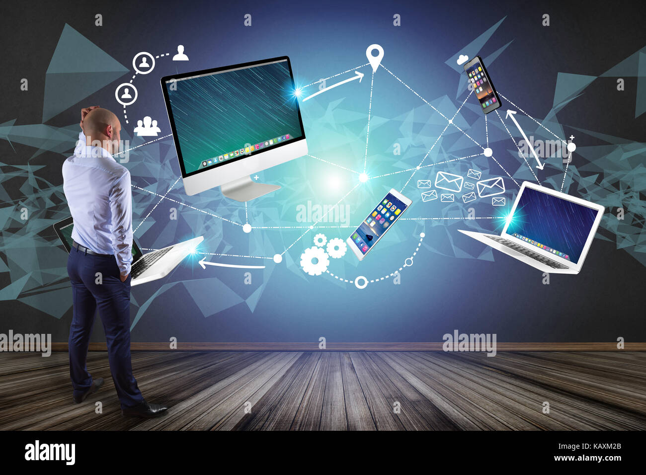 View of a Businessman in front of a wall with Computer and devices ...