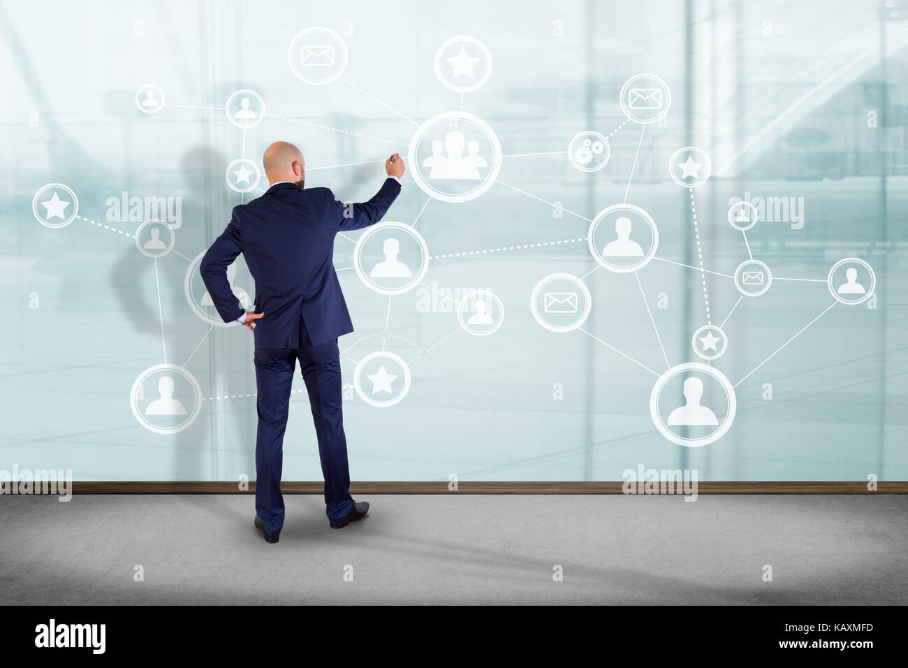 View of a Businessman in front of a wall with a business network ...