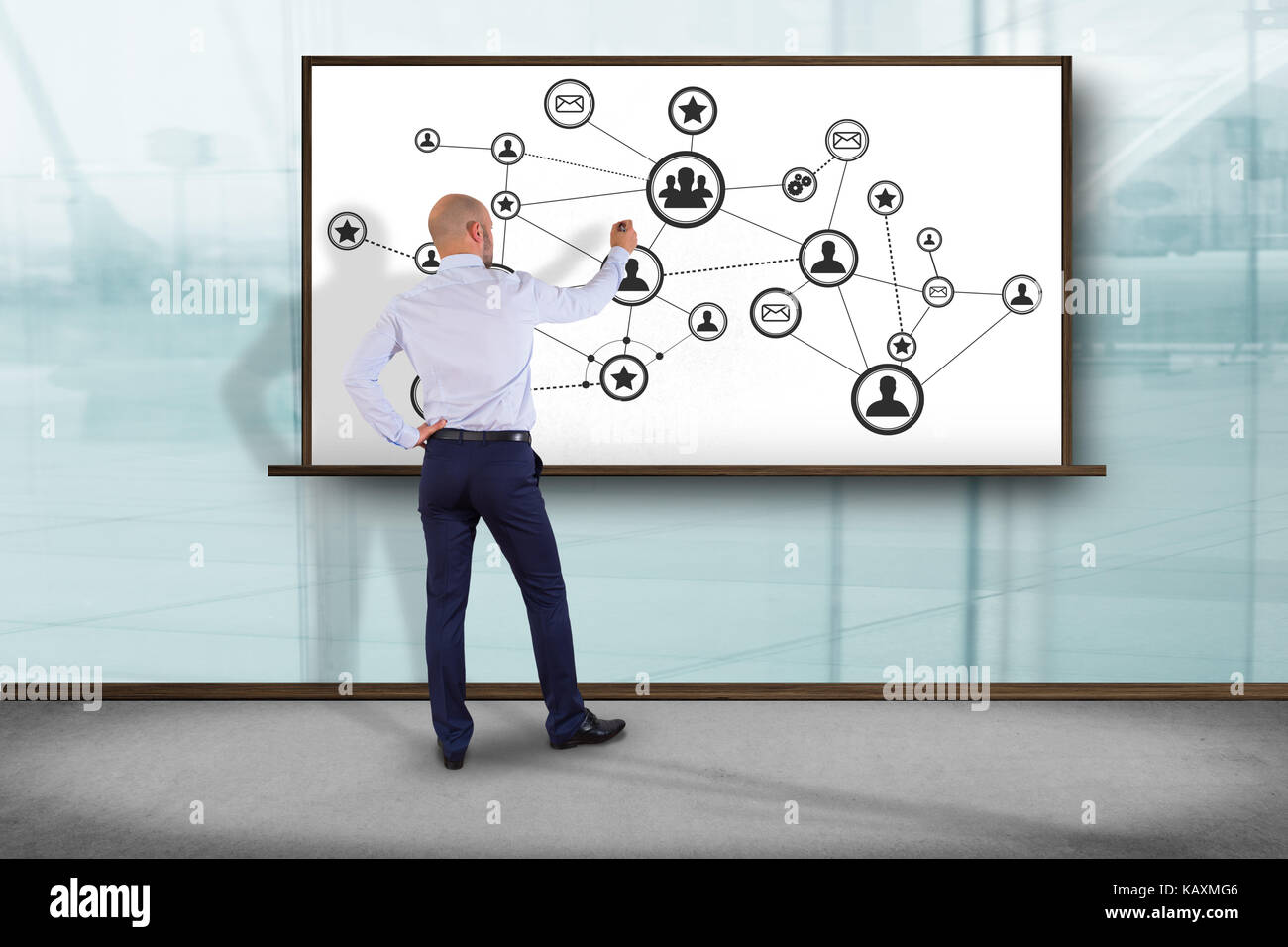 View of a Businessman in front of a wall with a business network ...