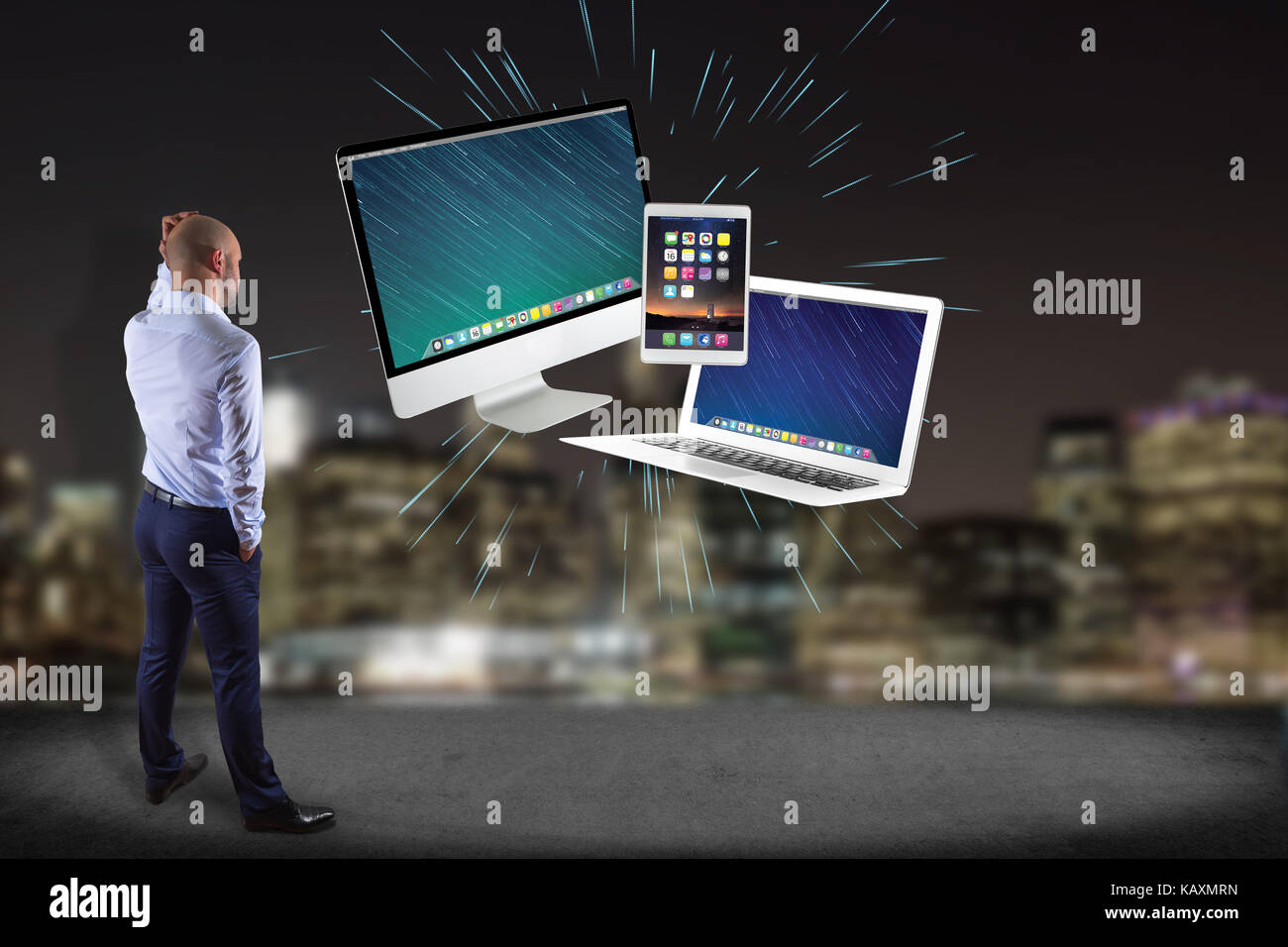 View of a Businessman in front of a wall with Computer and devices ...