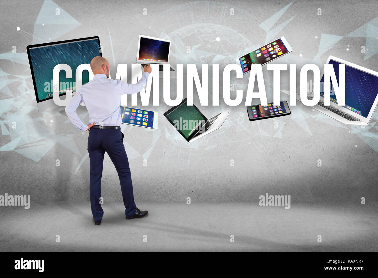 View of a Businessman in front of a wall with Communication title ...