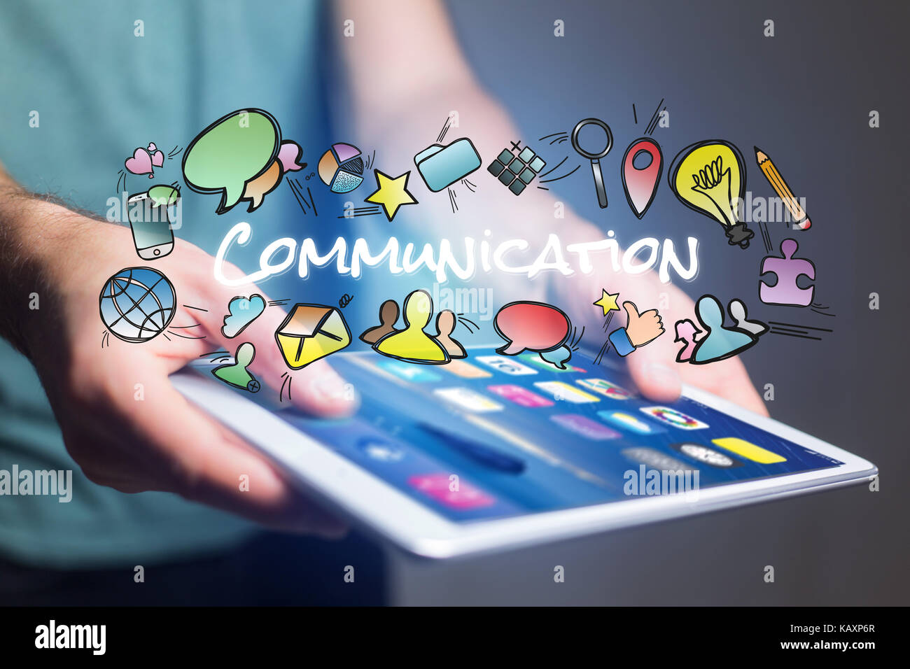 Concept view of man holding tablet with communication title and ...