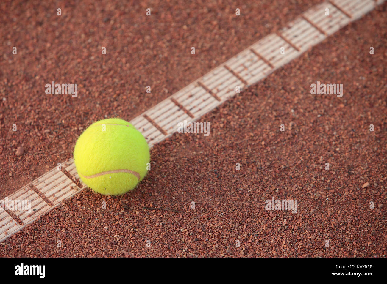 Tennis ball on the line, on clay court Stock Photo - Alamy