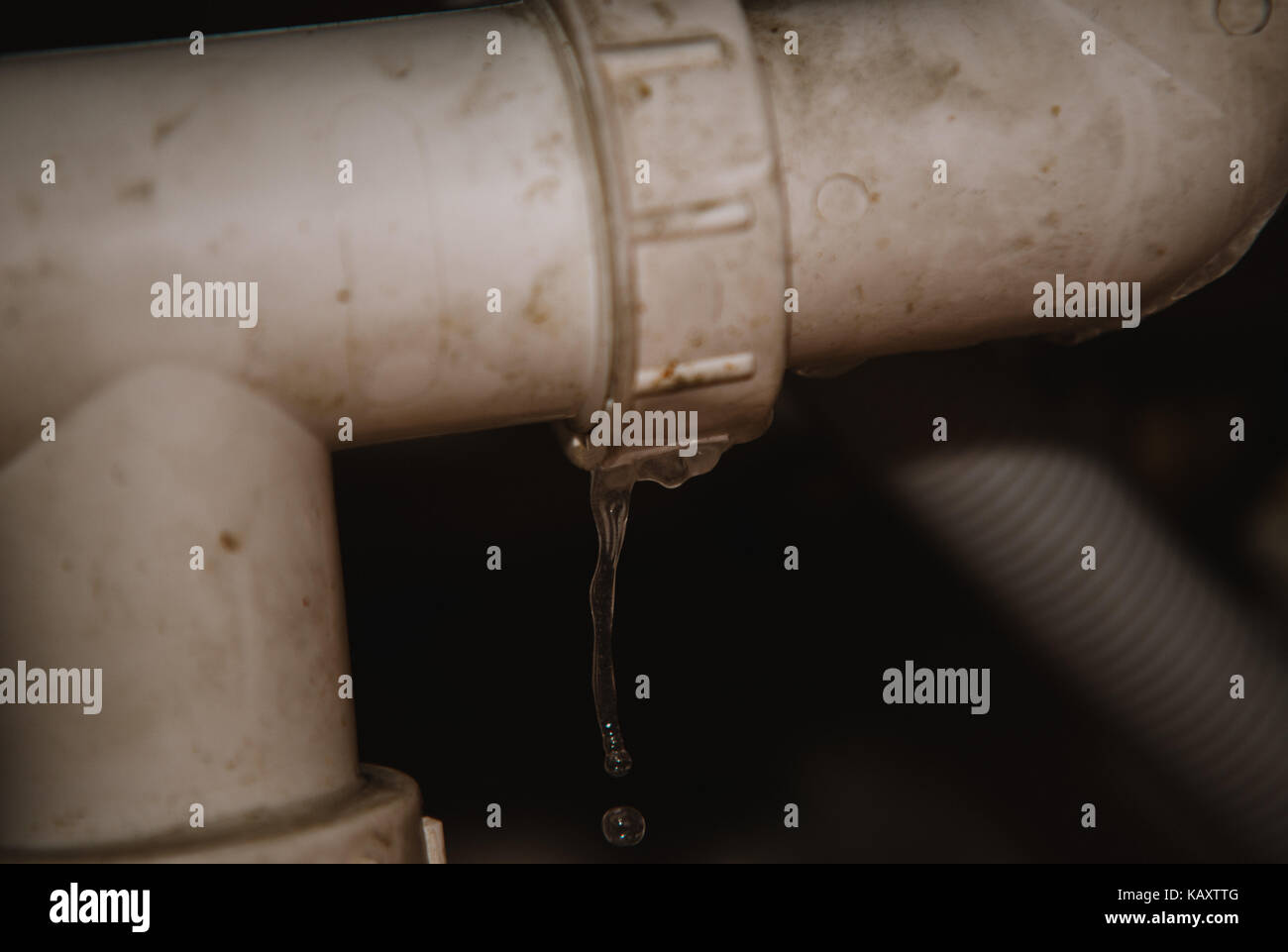 real Leakage Of Water From Pipe on home background Stock Photo - Alamy
