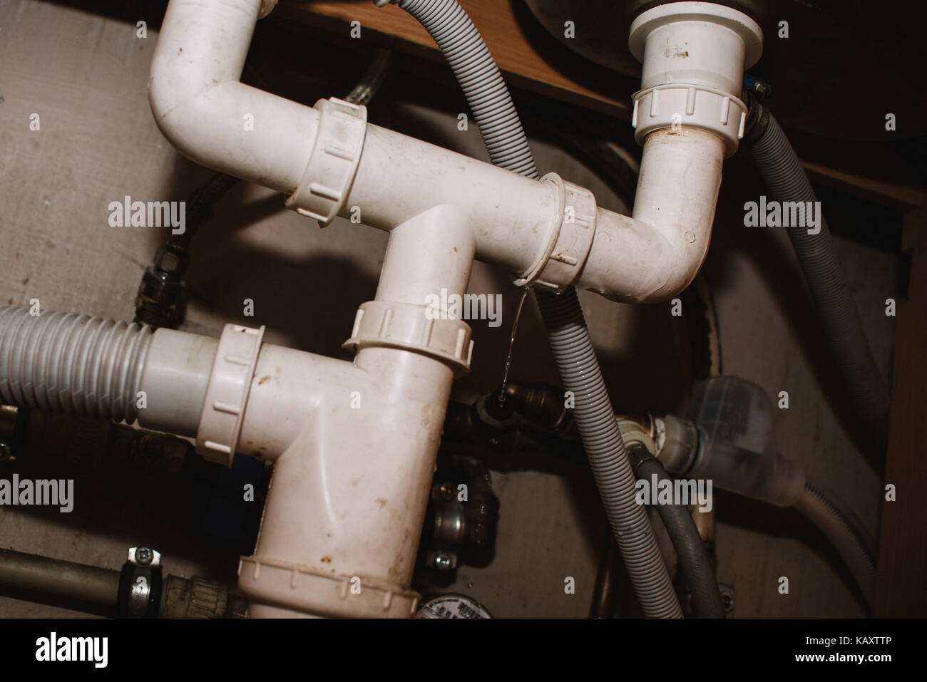 real Leakage Of Water From Pipe on home background Stock Photo - Alamy