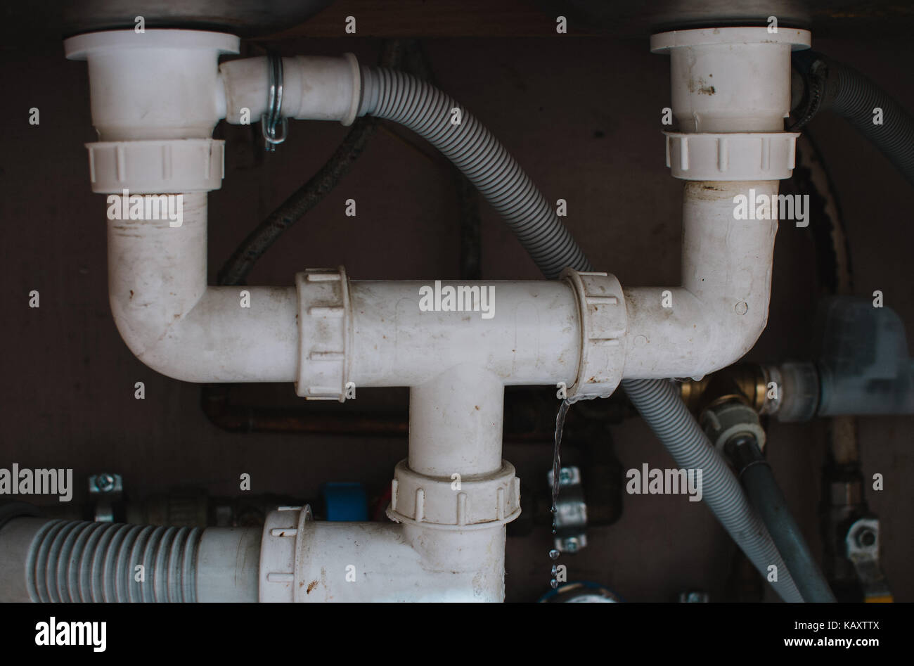 real Leakage Of Water From Pipe on home background Stock Photo - Alamy