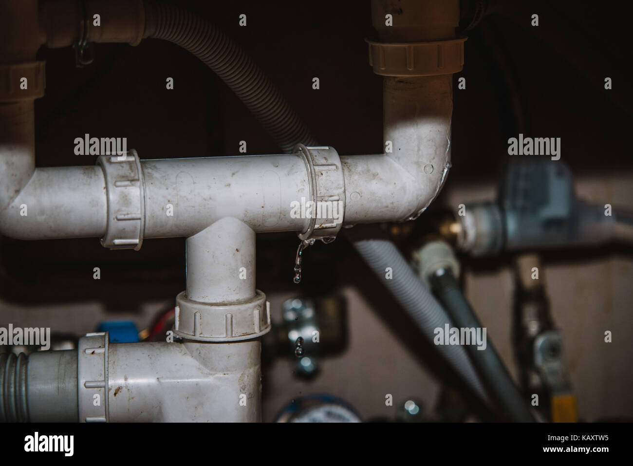 real Leakage Of Water From Pipe on home background Stock Photo - Alamy