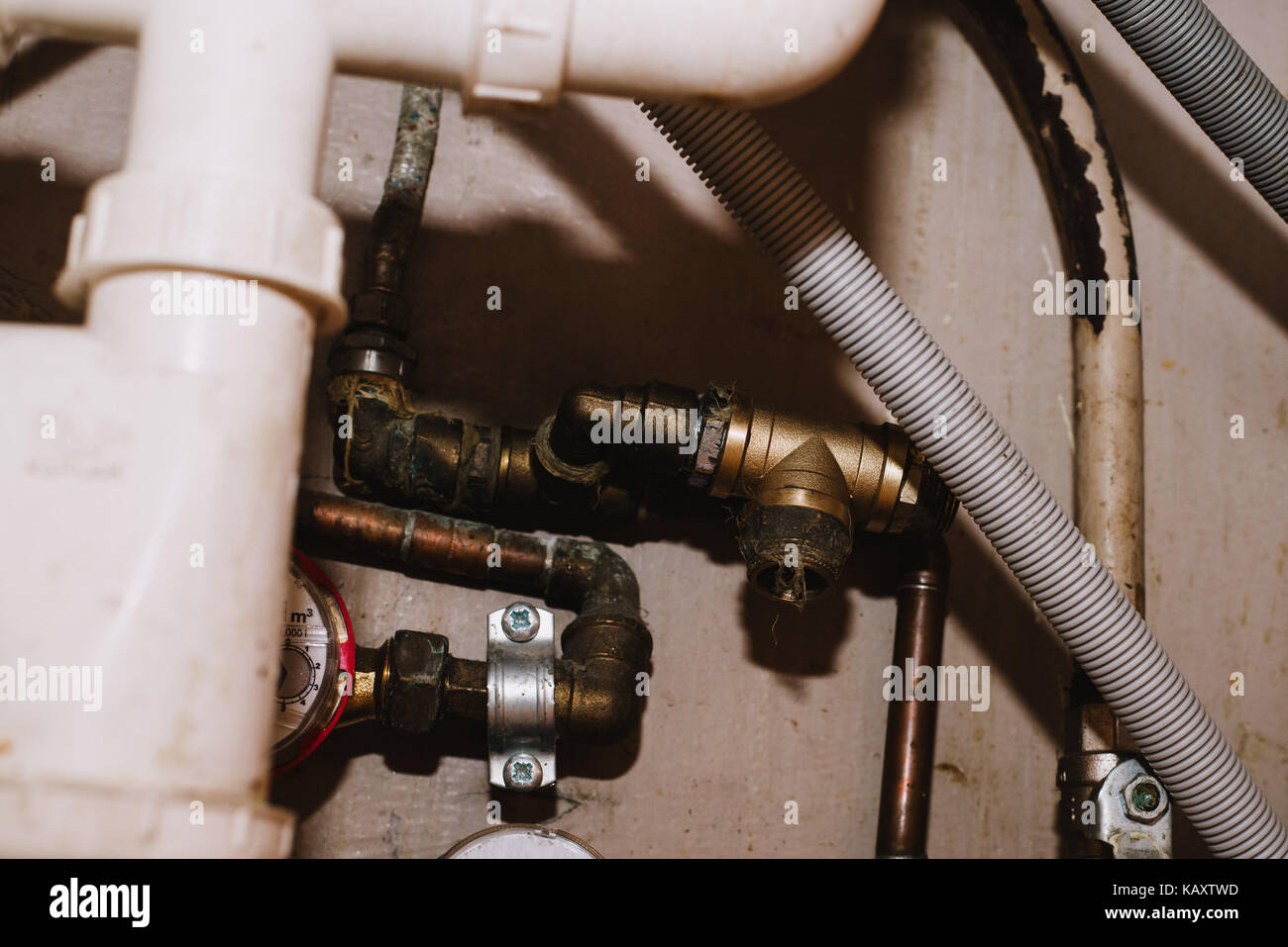 real Leakage Of Water From Pipe on home background Stock Photo - Alamy