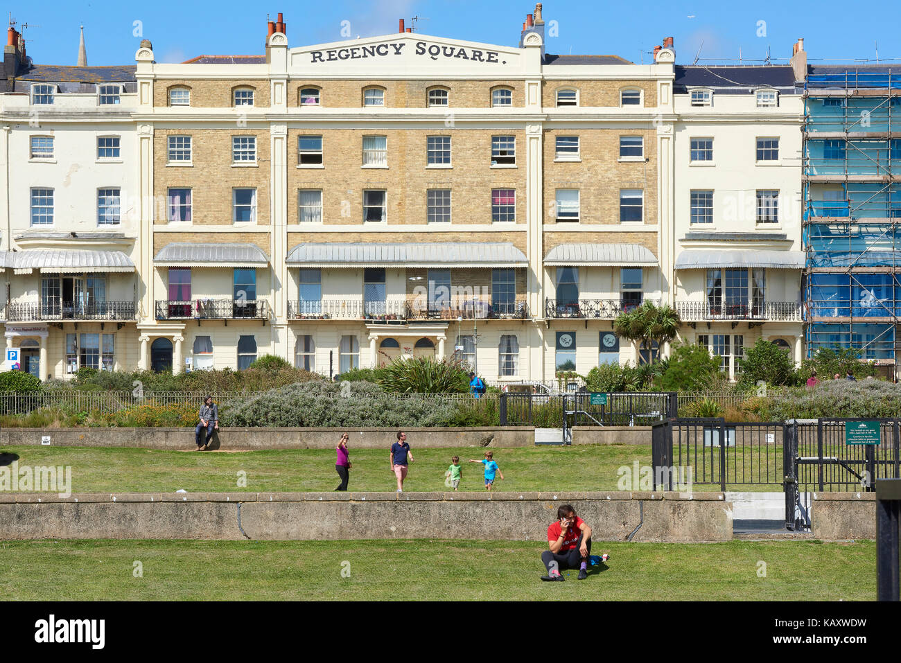 Public enjoying the sun in Regency square in Brighton, East Sussex, UK ...