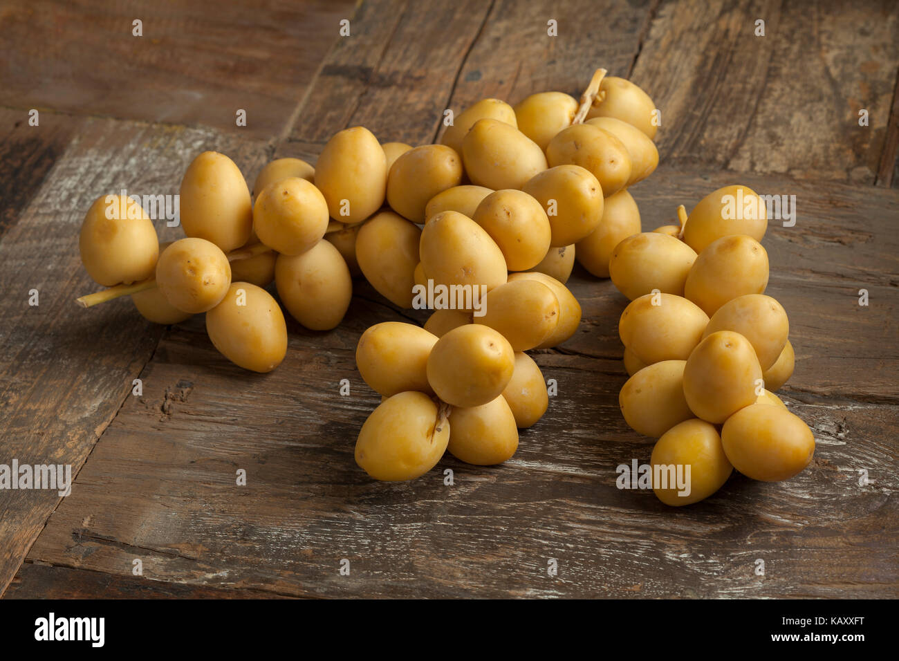 Bunch of fresh yellow dates on the table Stock Photo - Alamy