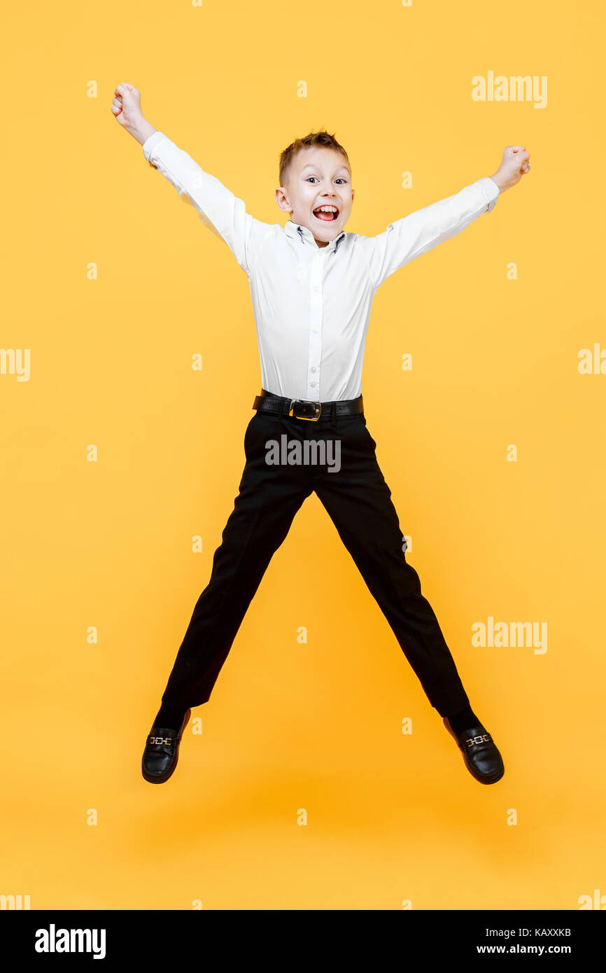 Happy schoolboy jumping for joy. Happiness, activity and child concept ...