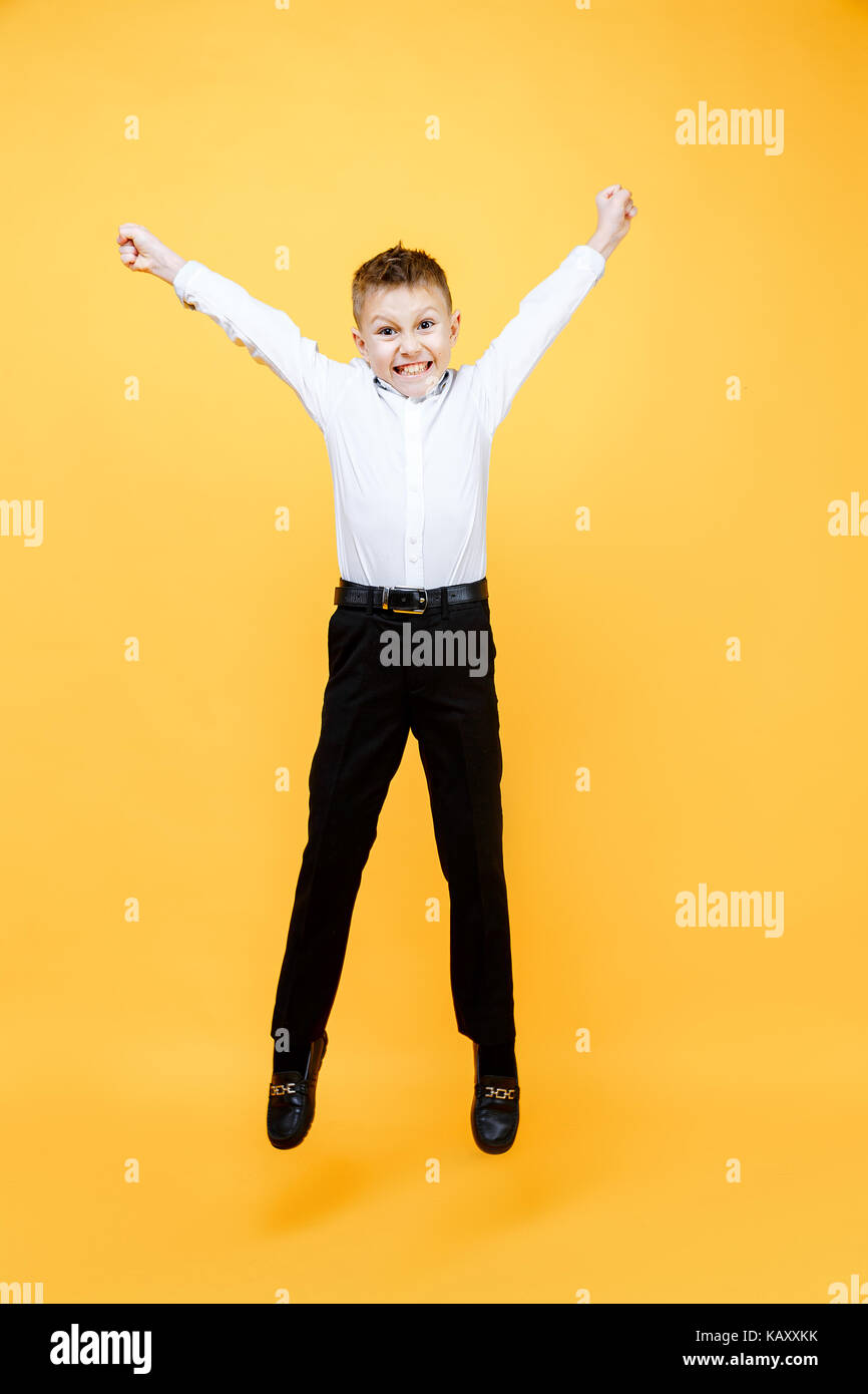 Happy schoolboy jumping for joy. Happiness, activity and child concept ...