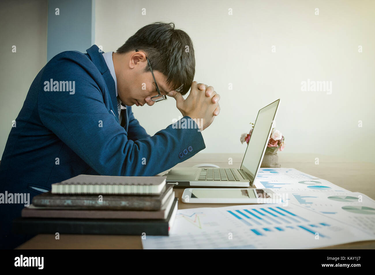 portrait of stressed business man with document graph in the office ...