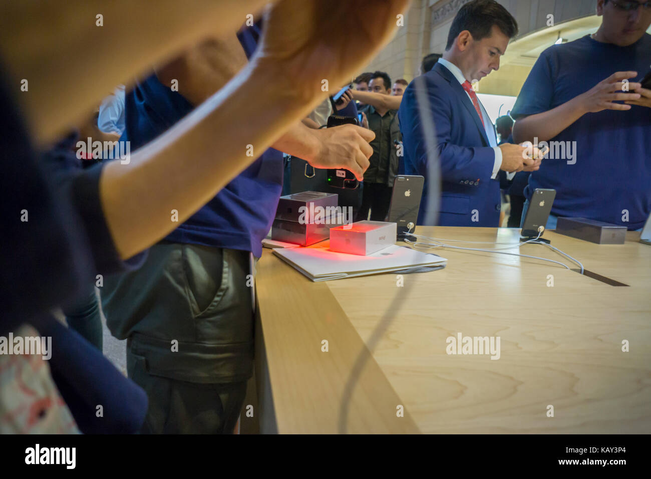 An Apple employee scans an iPhone 8 purchase in the Apple store in ...