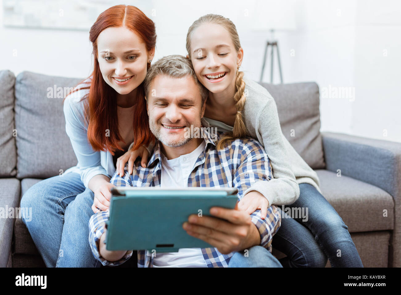 family using tablet Stock Photo - Alamy